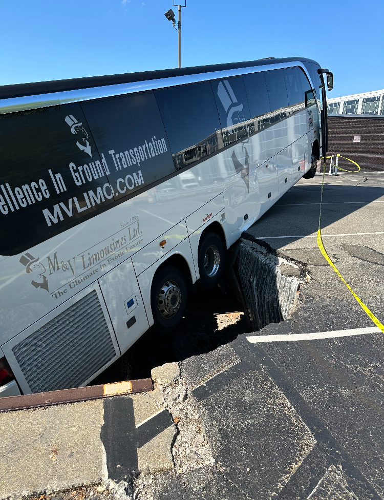 Tour bus that fell through North New Hyde Park garage pulled out after ...